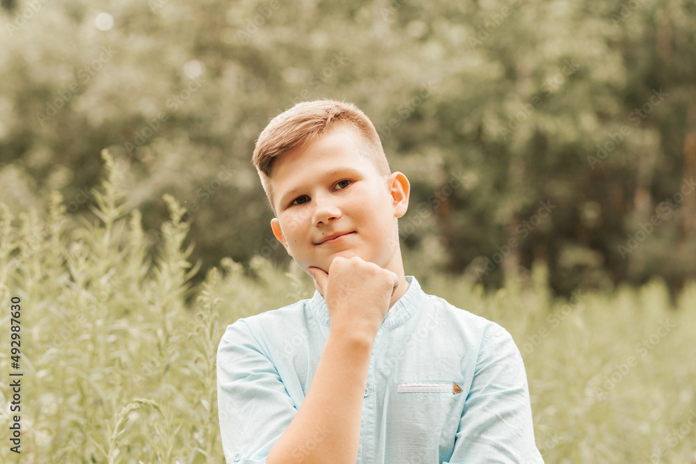 Young boy posing at the summer park. Cute smiling happy 11 years old ...