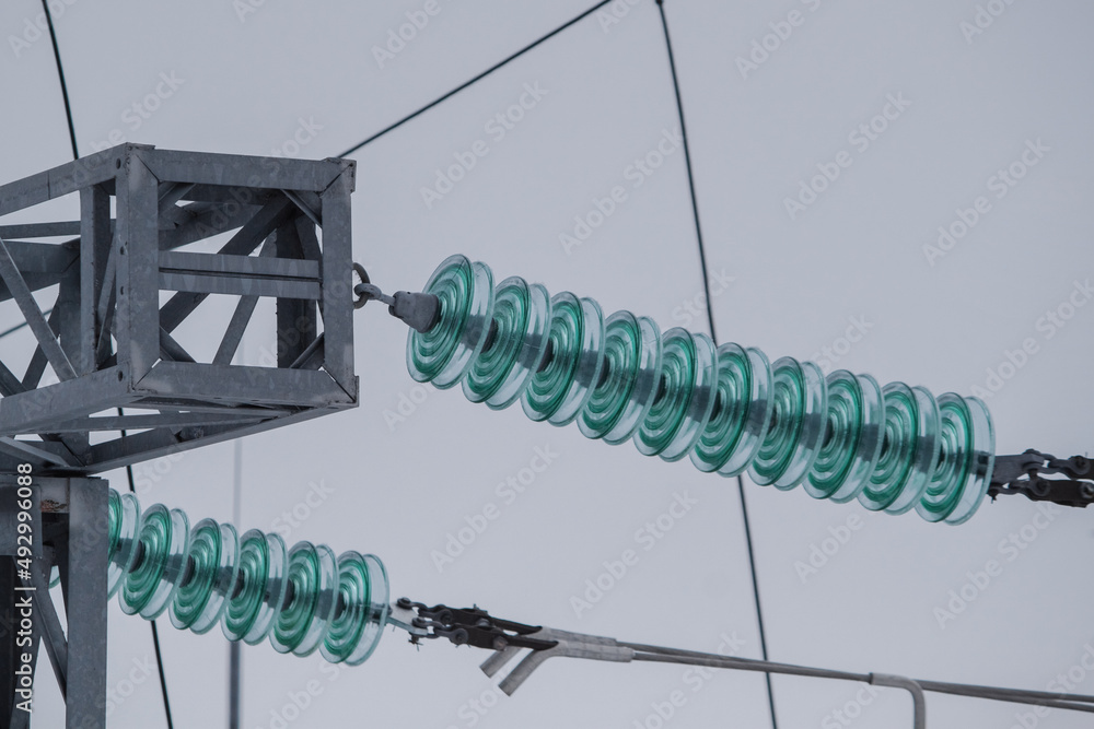 High-voltage line insulators at an electrical substation. Electric ...