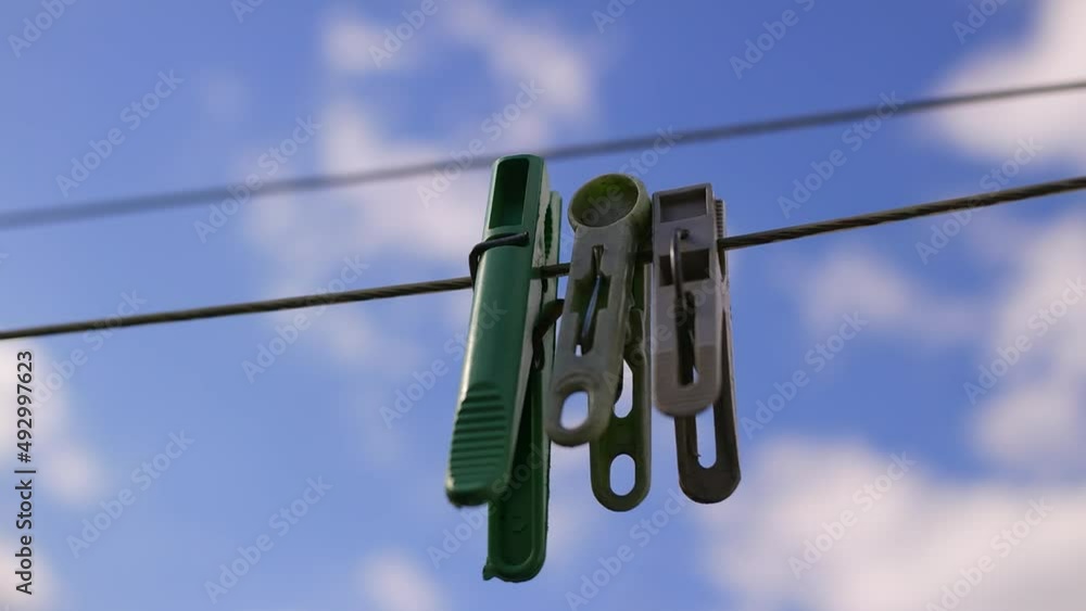 old pegs on a rope. One old retro clothespin wooden on a linen rope ...