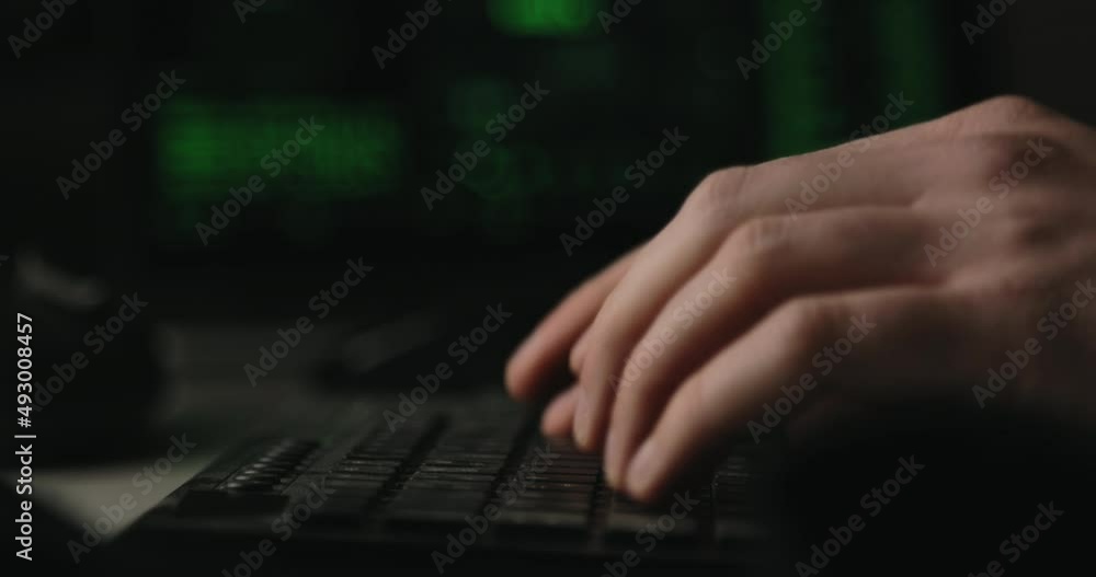 Hacker is typing keys on a keyboard in his room Stock Video | Adobe Stock