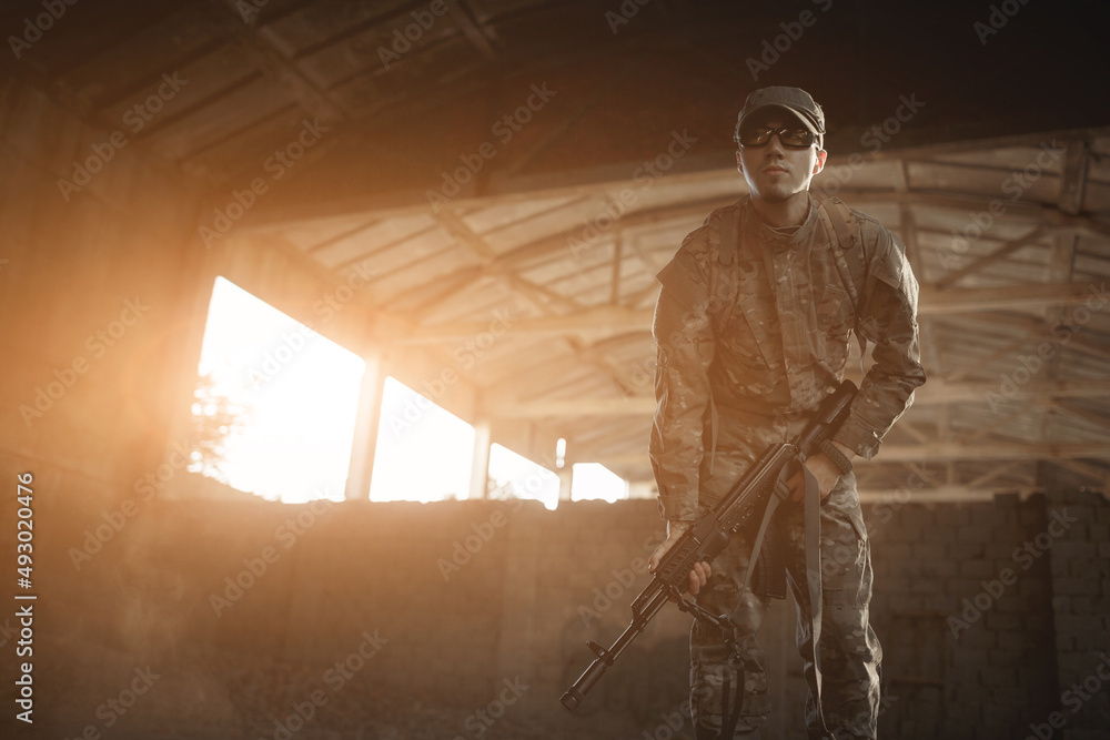 a young conscript soldier without combat experience in a gray ...