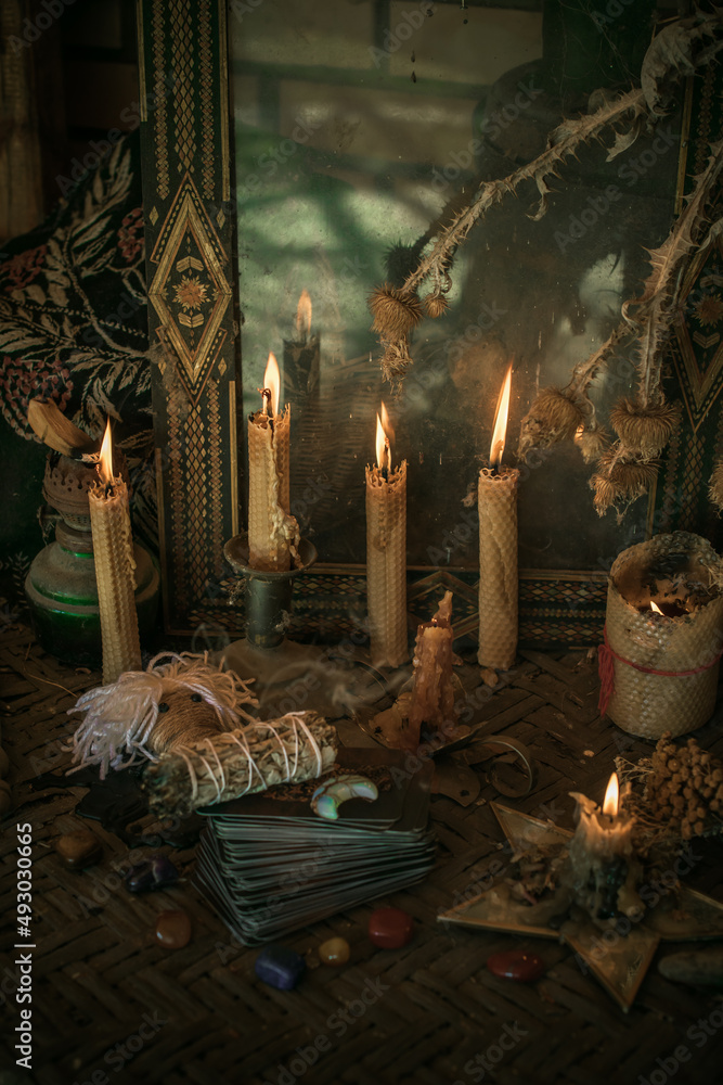 Candle burns on the altar, powerful magic among candles, pagan or wicca ...