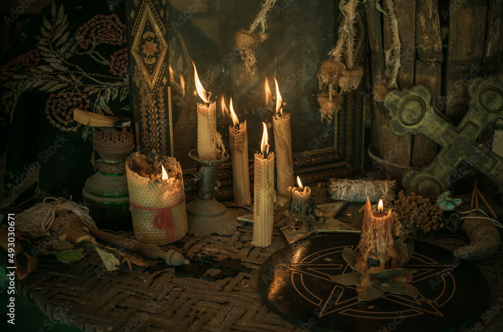 Candle burns on the altar, powerful magic among candles, pagan or wicca ...