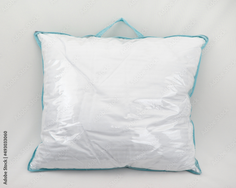 White pillow in a plastic bag with a carrying handle. Mock up template ...