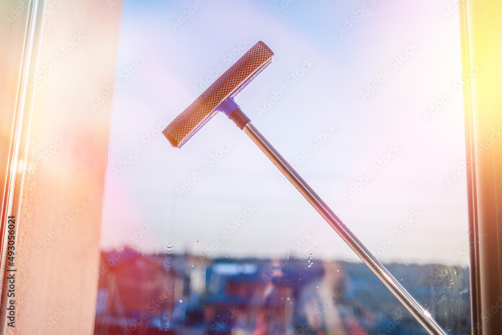 Window cleaning in high-rise buildings, houses with a brush. Window ...