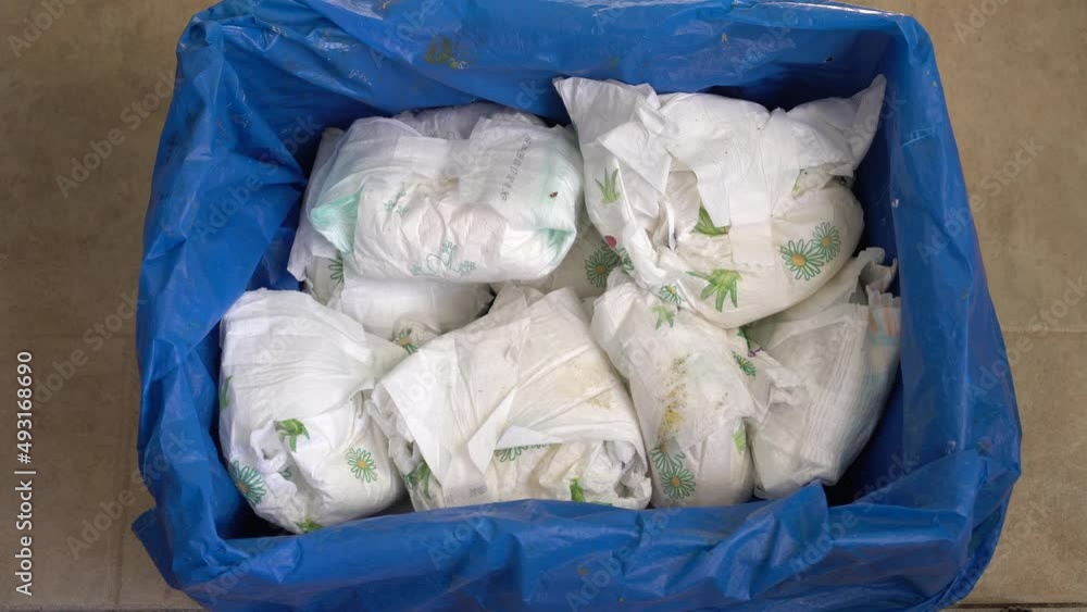 Dirty baby diapers in the trash. Disposing of used nappies. The problem ...