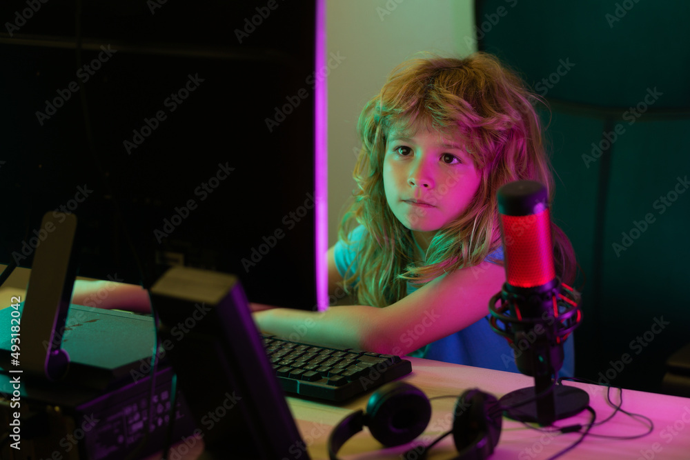 Little kid using desktop pc by night, child boy illuminated by the blue ...
