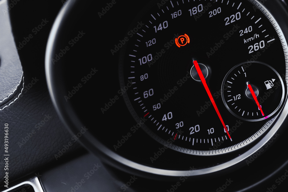 Car speedometer, luxury dashboard with glowing red indicators close-up ...