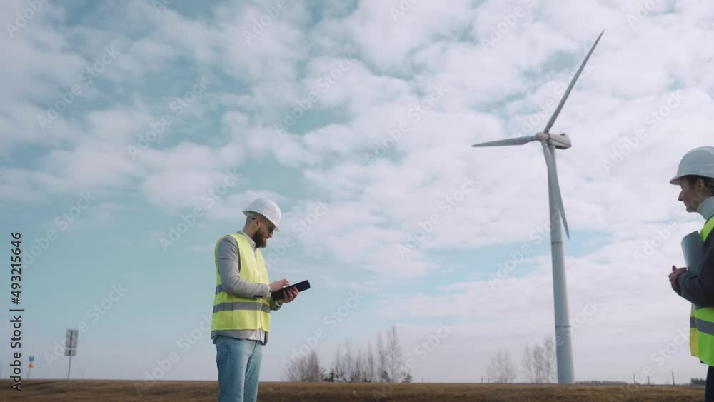 Environmental engineers work at the sustainable power station, wearing ...