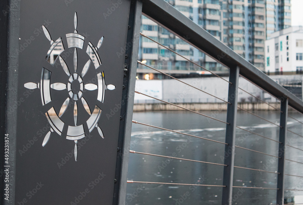 Symbol of a ship's rudder, helm, nautical steering wheel as an element ...