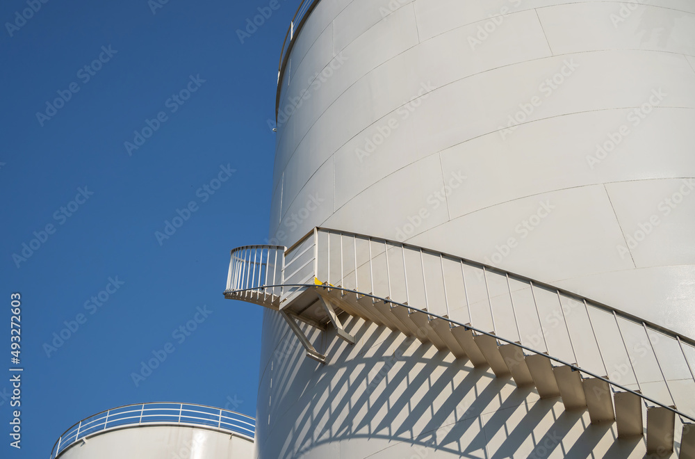 Curved stairway of base oil storage tank in the petroleum factory with ...
