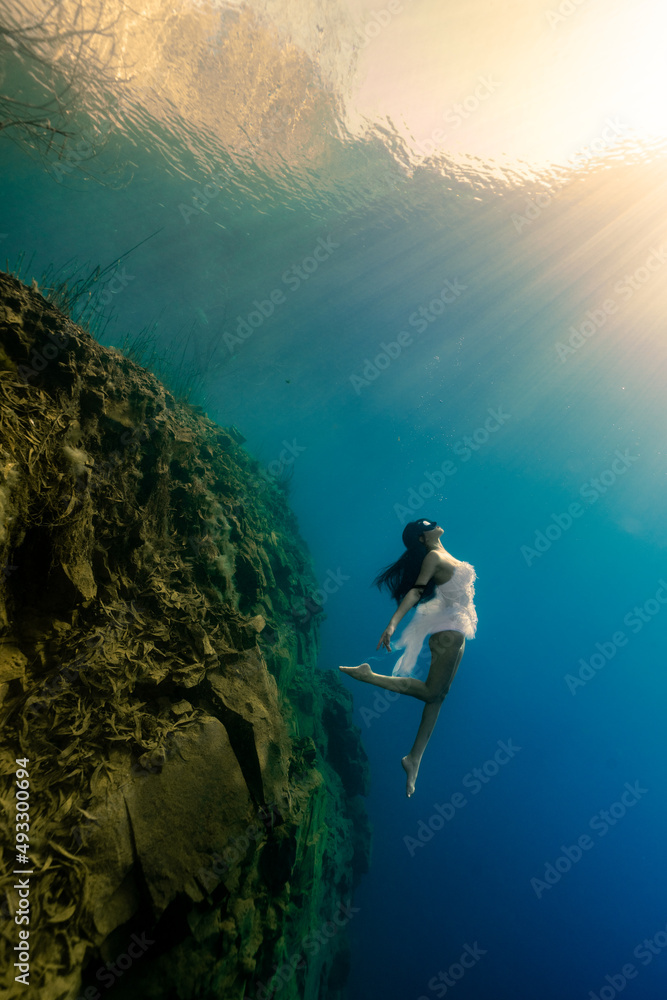 Female floating underwater Stock Photo | Adobe Stock