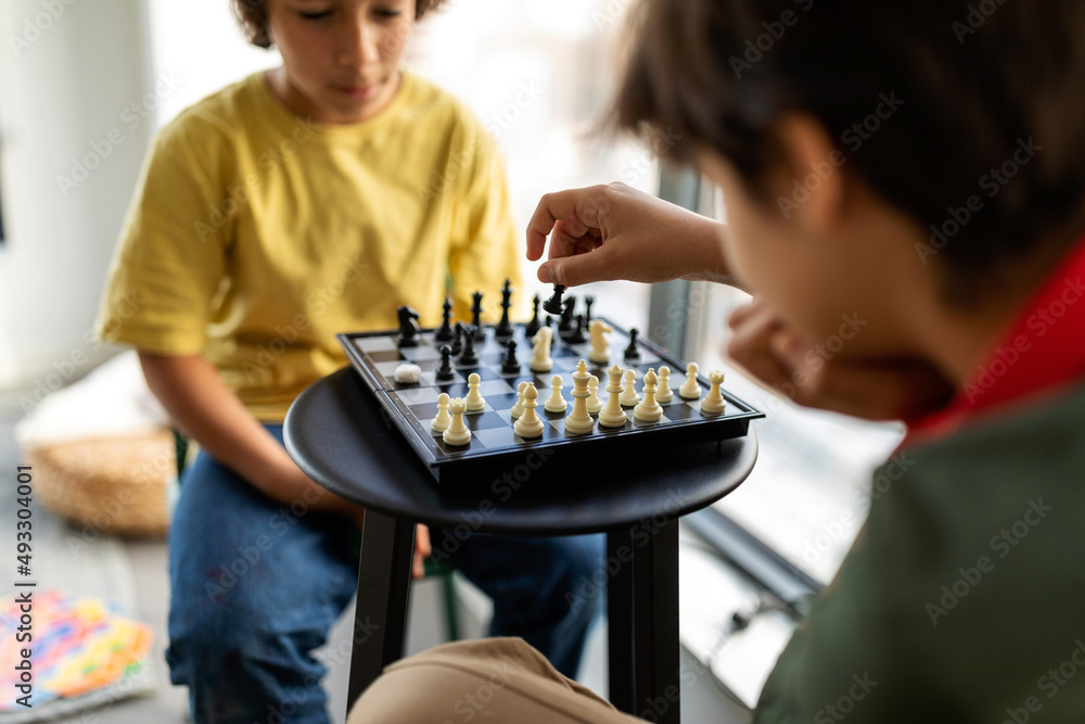 Kids playing chess indoor Stock Photo | Adobe Stock