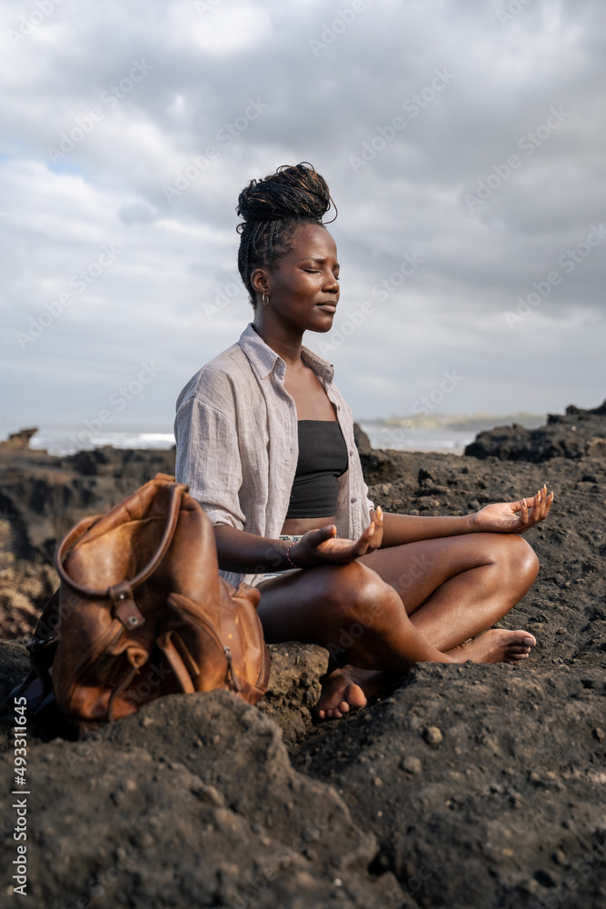 Meditating black woman in nature Stock Photo | Adobe Stock