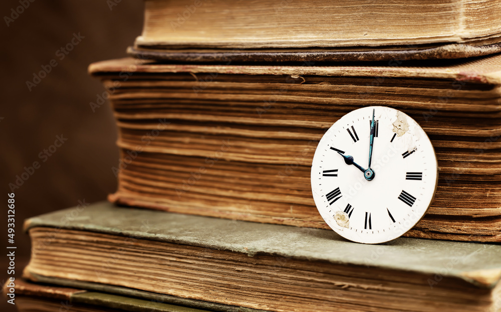 Old books and vintage antique clock face. Story time, storytelling ...