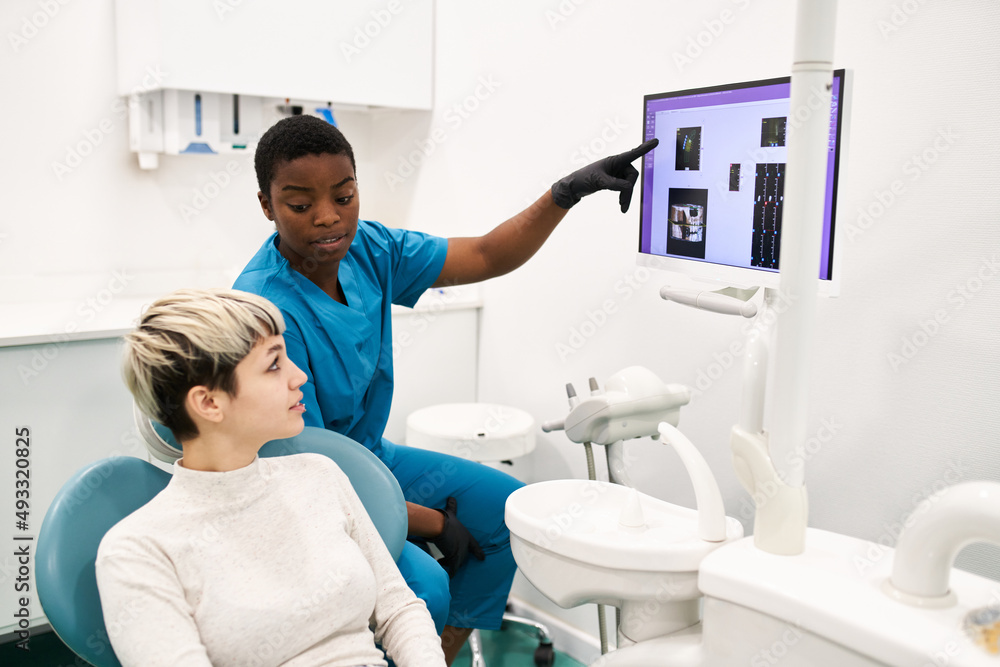 Dentist examining teeth scans Stock Photo | Adobe Stock