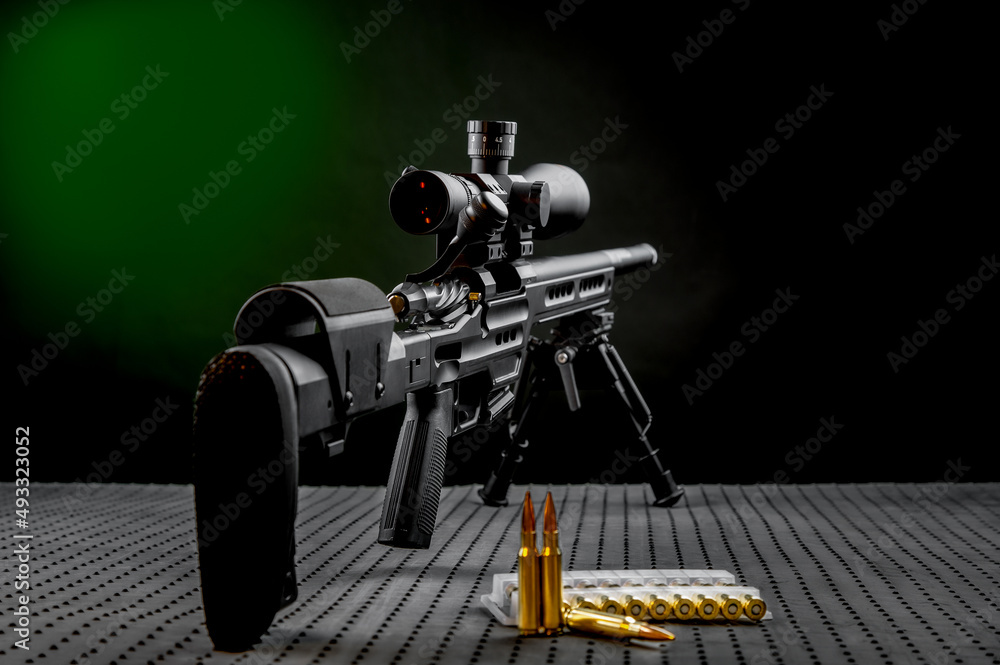 Modern powerful sniper rifle with a telescopic sight mounted on a bipod ...