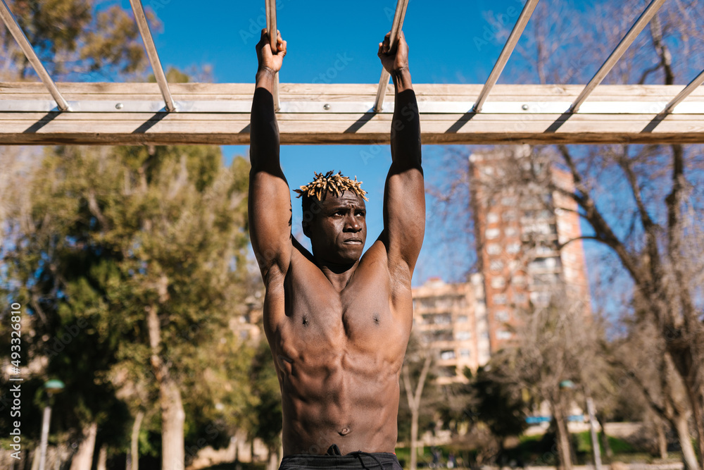 Muscular African man exercising on calisthenics bars Stock Photo ...