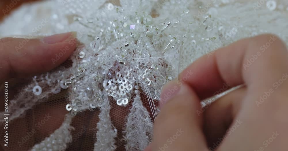 seamstress hand needle dress. neat female white hands holding a needle ...