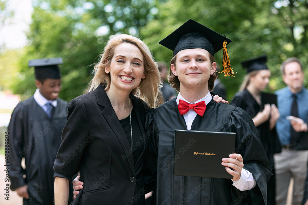 Grad: Parent And Child Pose With Diploma Stock Photo | Adobe Stock