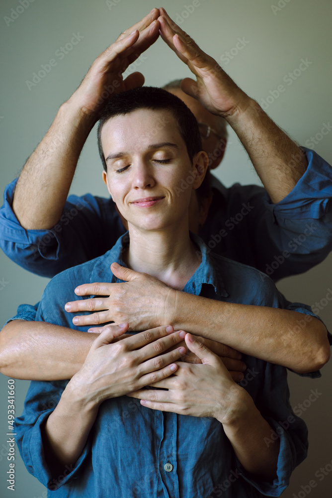 Parents hug their daughter with short hairstyle Stock Photo | Adobe Stock