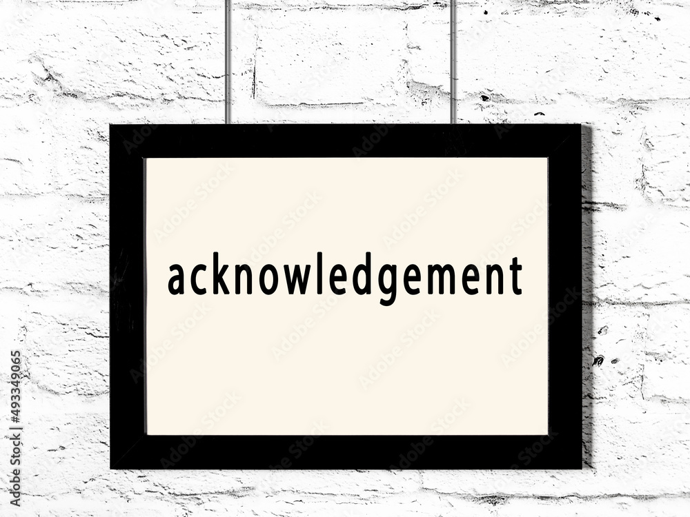 Black frame hanging on white brick wall with inscription ...