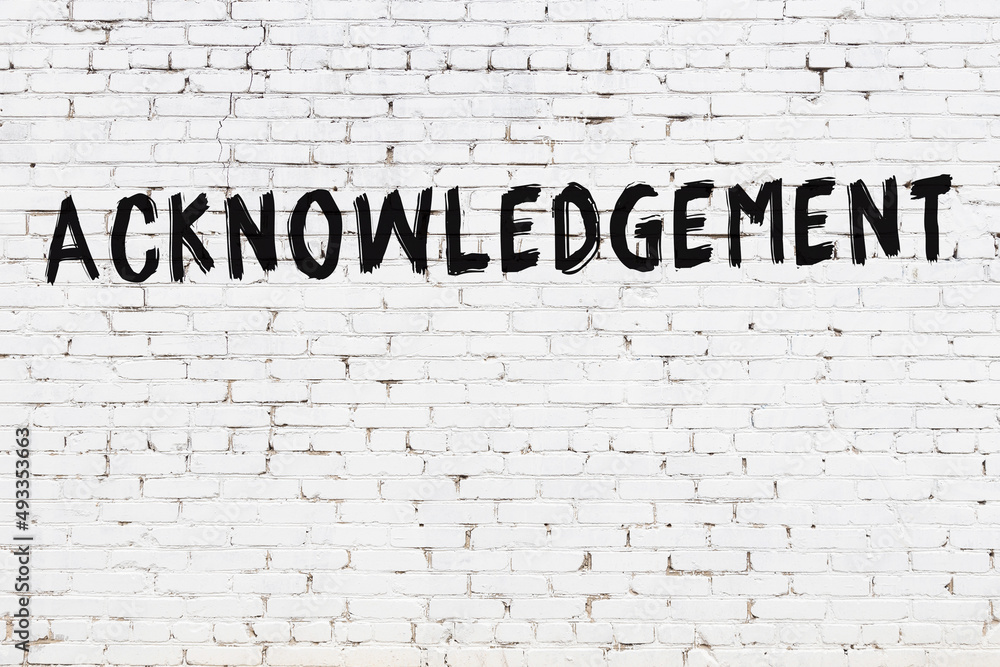 Inscription acknowledgement painted on white brick wall Stock ...