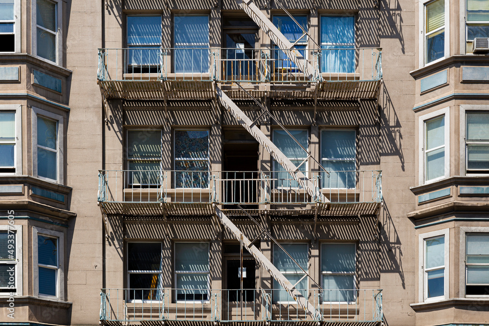 Balconies with emergency stairs of a building Stock Photo | Adobe Stock