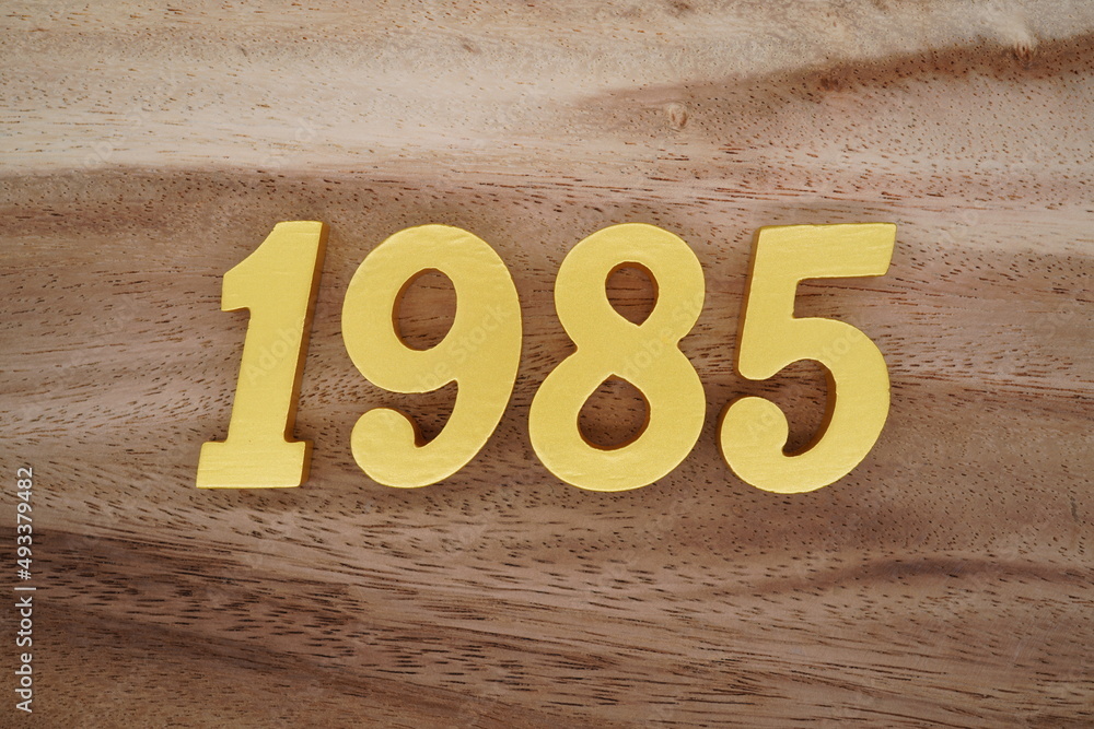 Golden Arabic numerals on a real brown and white wooden floor number ...