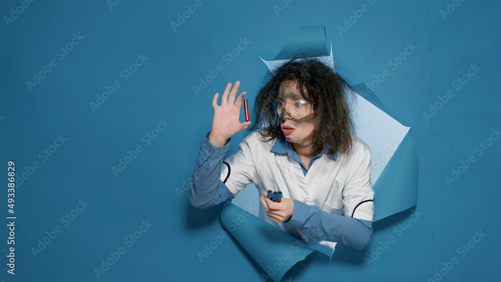 Crazy silly scientist grinning and showing test tubes on camera, doing ...