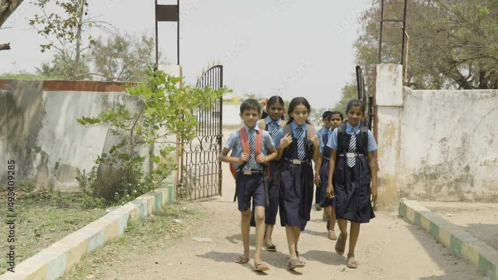 group of kids in uniform coming to school through gate - concept of ...