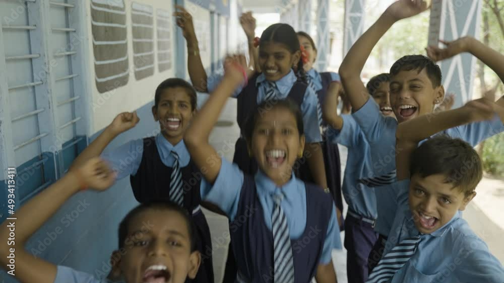 Group of cheerful students shouting by looking camera at school ...
