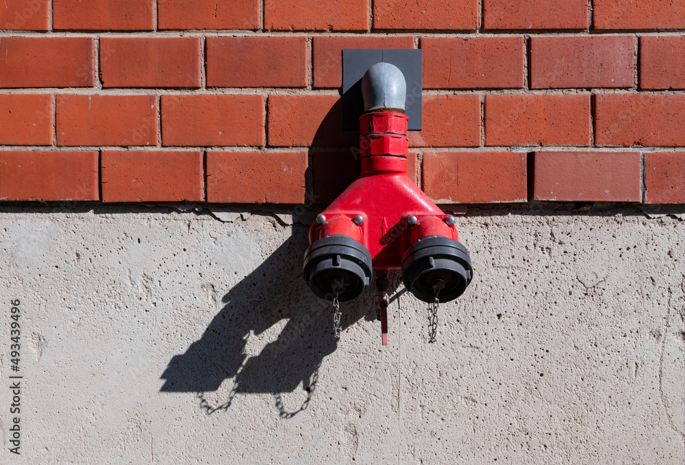 Red waterline connection for fire extinguishing. Metal interface on a ...