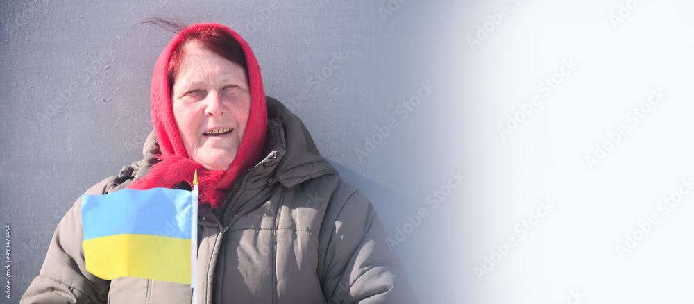 Portrait Of Old Ukrainian Women Of 60 Years Old Holding Flag Of Ukraine portrait-of-old-ukrainian-women-of-60-years-old-holding-flag-of-ukraine