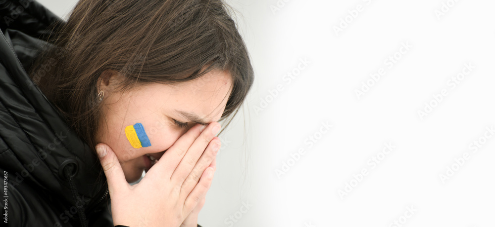 Pray for Ukraine.Portrait of Ukrainian girl with national flag on cheek ...