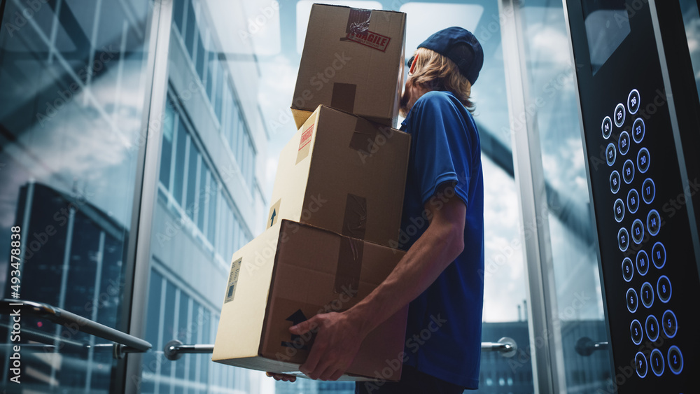 Young Delivery Person Riding Glass Elevator in Modern Office Building ...