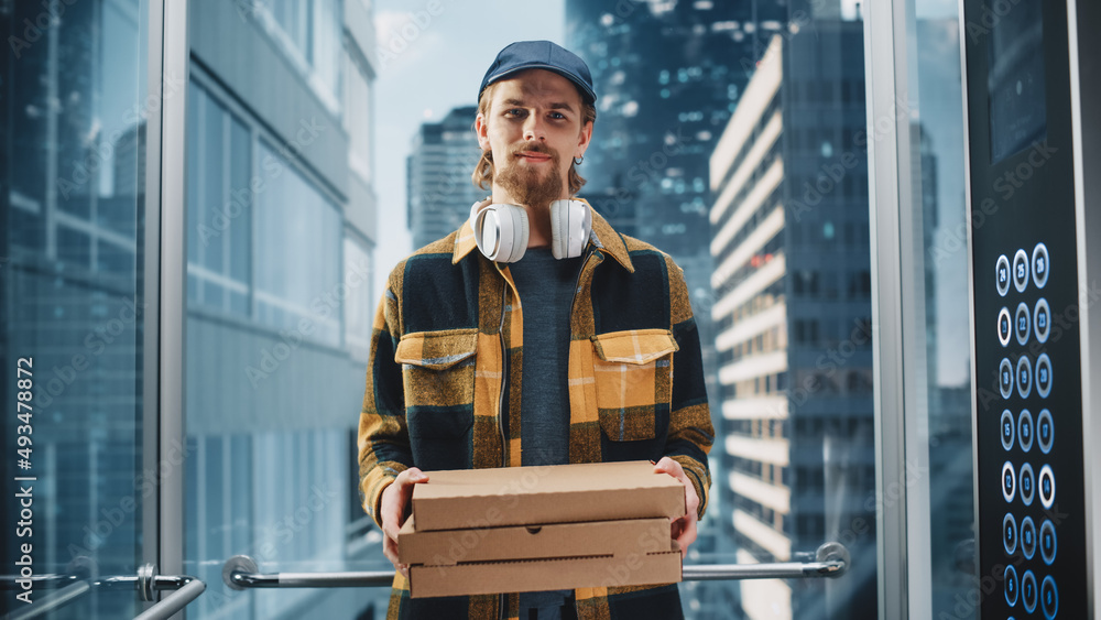 Young Handsome Food Delivery Person Riding Glass Elevator in Modern ...