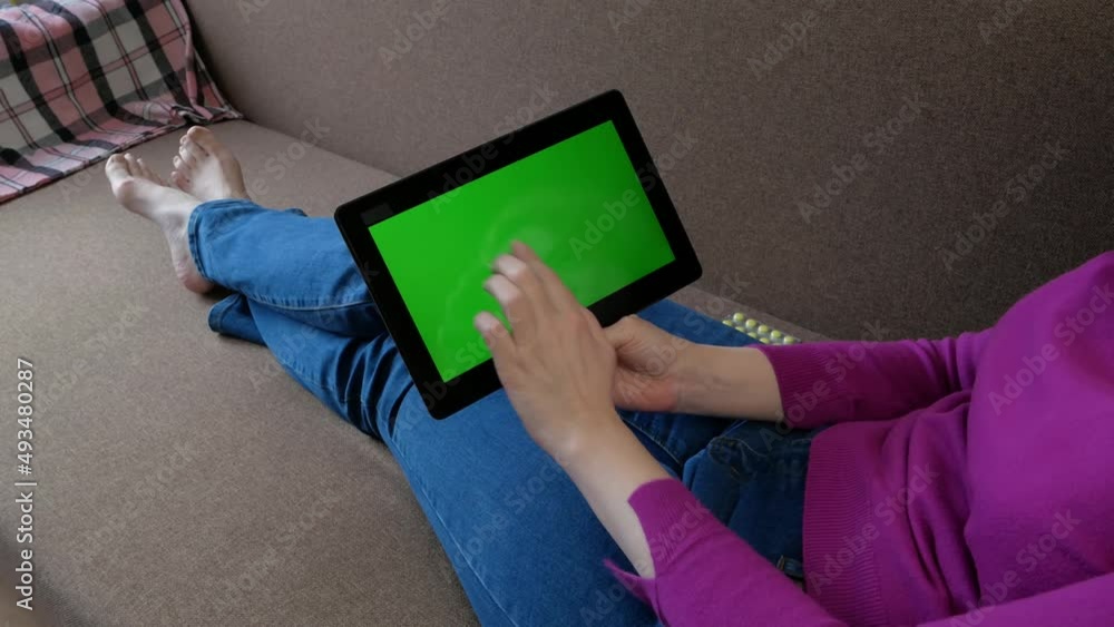 woman holding black tablet pc with blank desktop green screen sitting ...