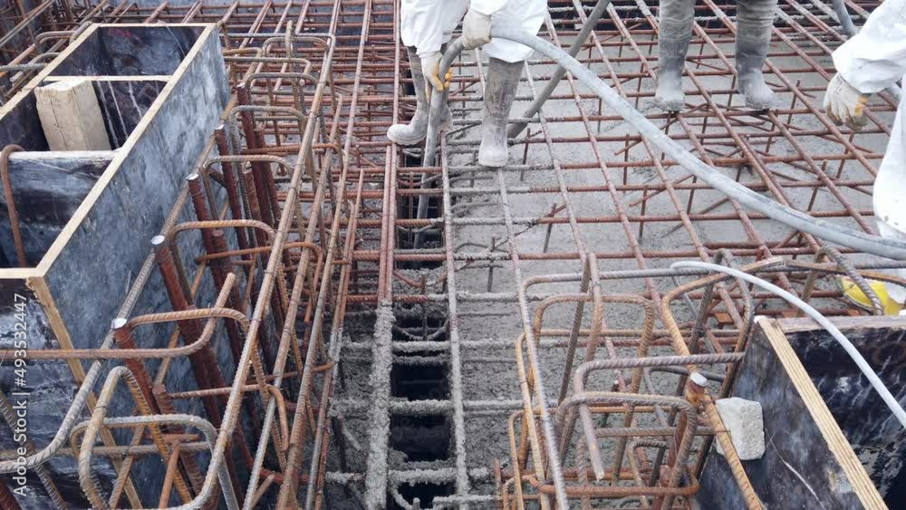 Vídeo do Stock: Construction workers dressed in protective workwear use ...