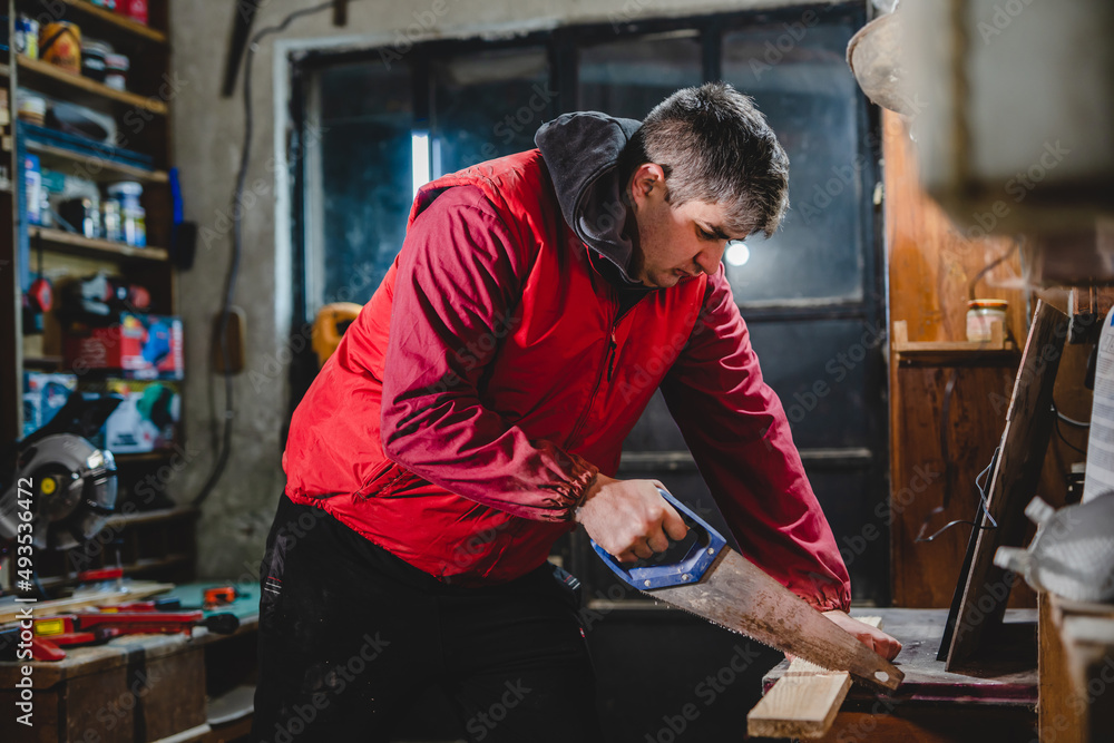 One man carpenter working at his garage workshop hobby and craft ...