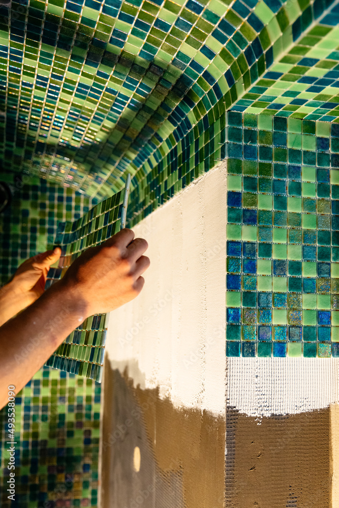 Applying modern mosaic tiles. Spa or sauna relaxation modern room ...