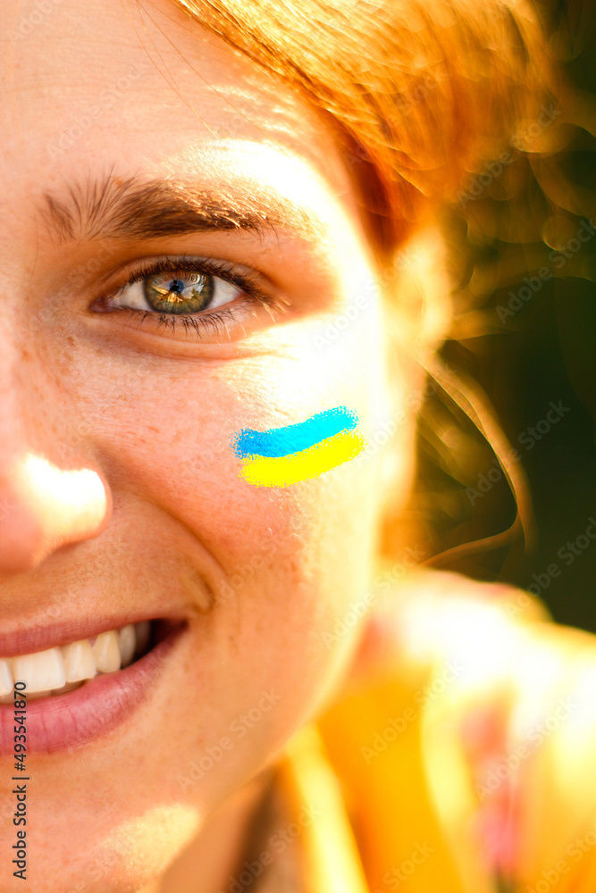 Ukrainian woman. Ukrainian flag on the cheeks. Selfie of a young woman ...