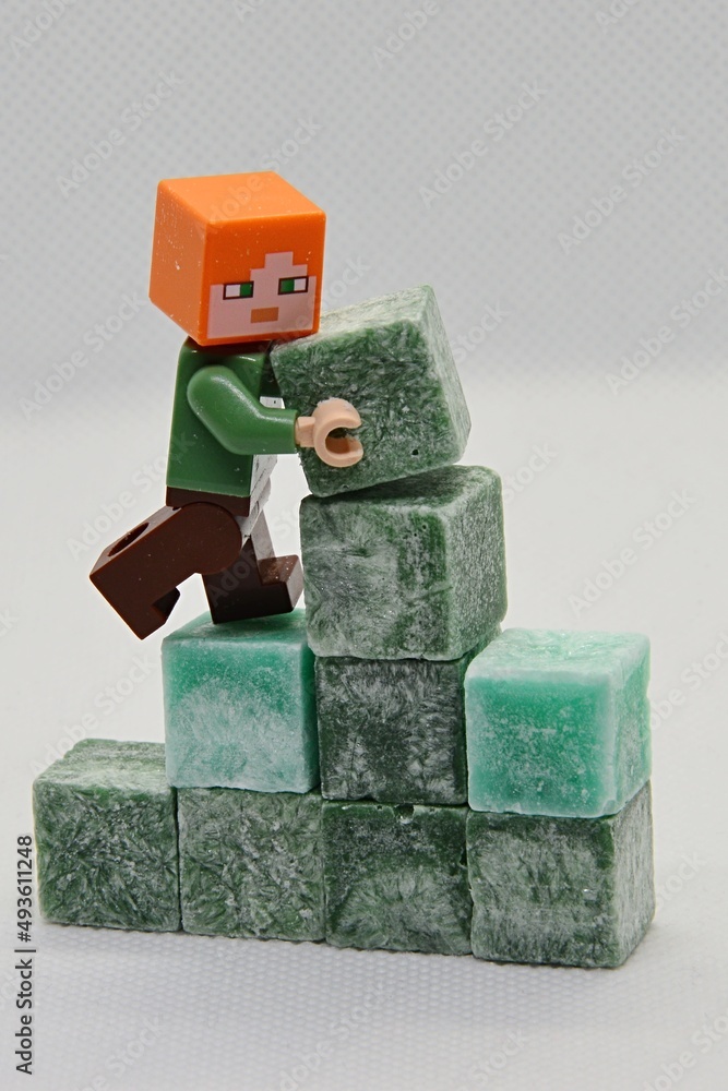 LEGO Minecraft figure of Alex is building a tower from scented green ...