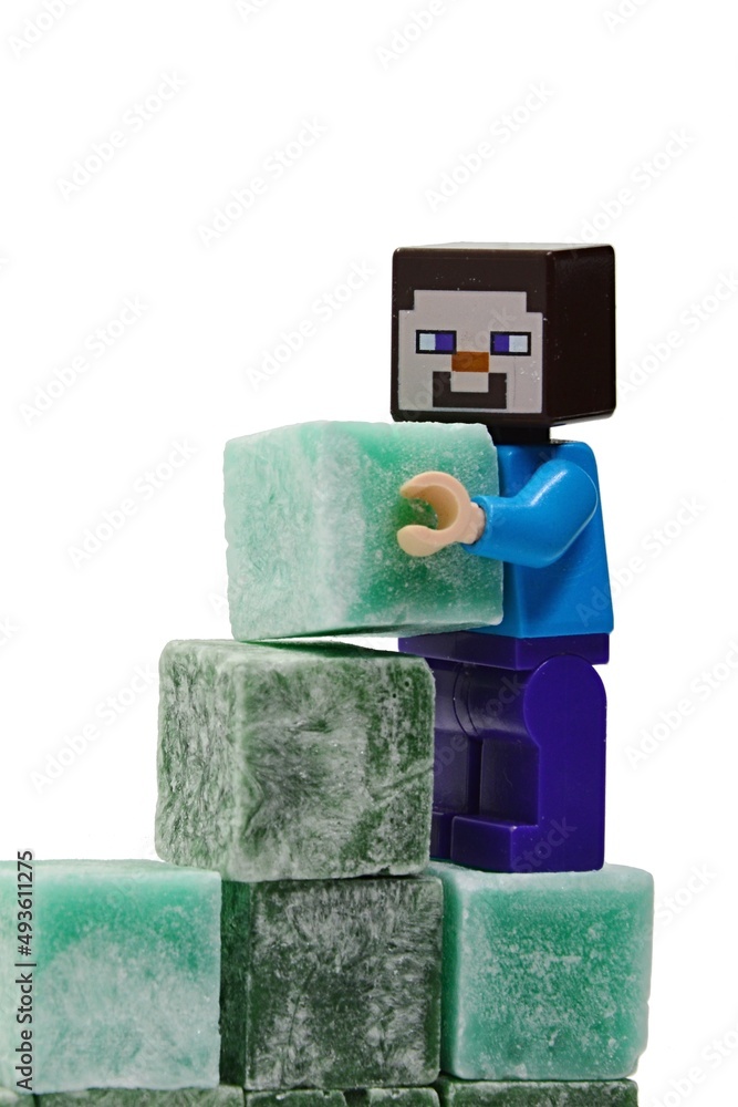 LEGO Minecraft figure of Steve is building a wall from green scented ...