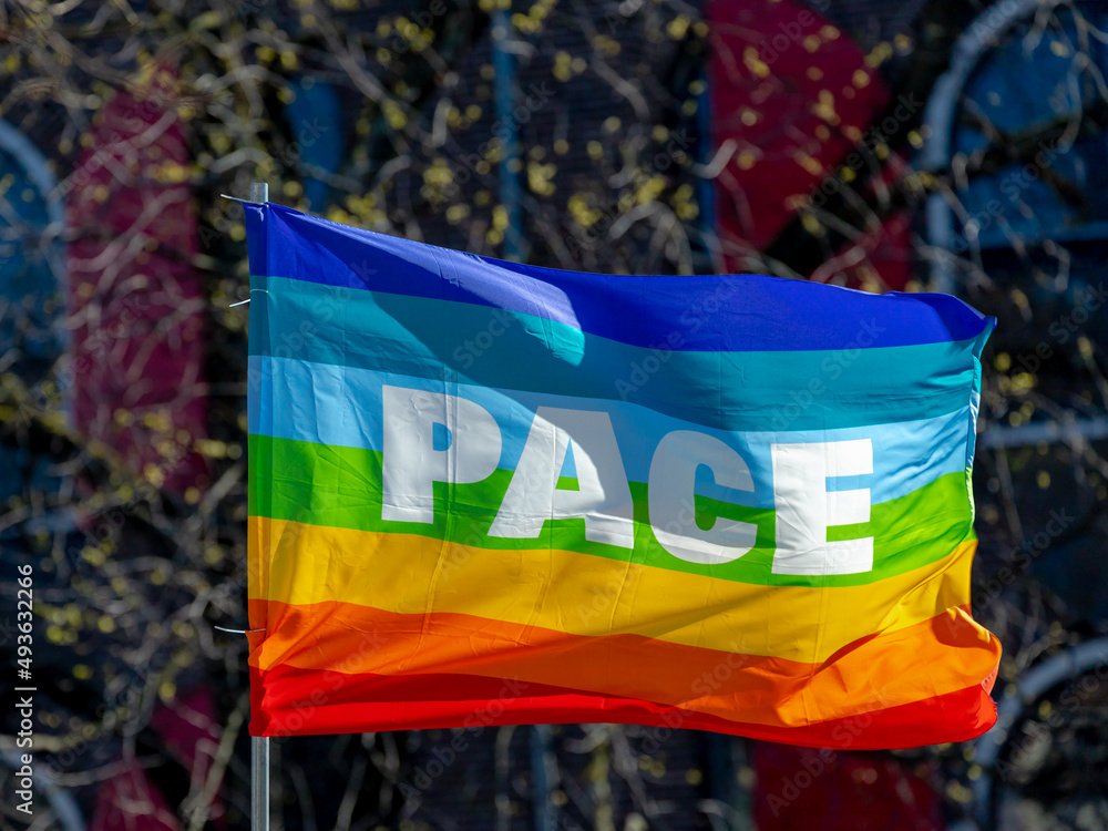 Rainbow flag on the pole with the word PACE waving in the air, The ...