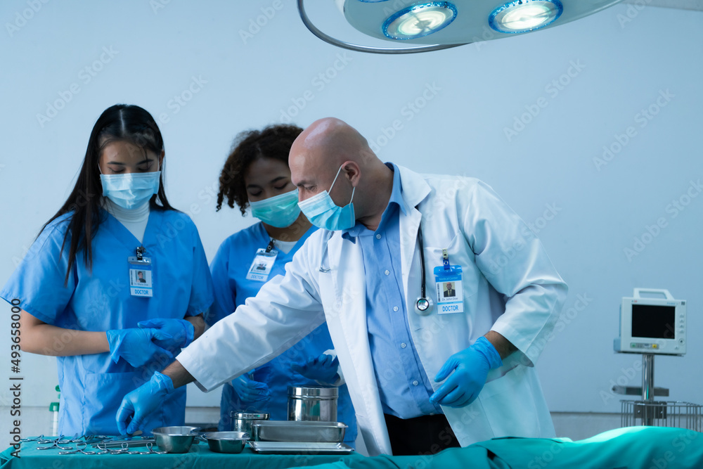A medical professor is teaching surgery to medical students working ...