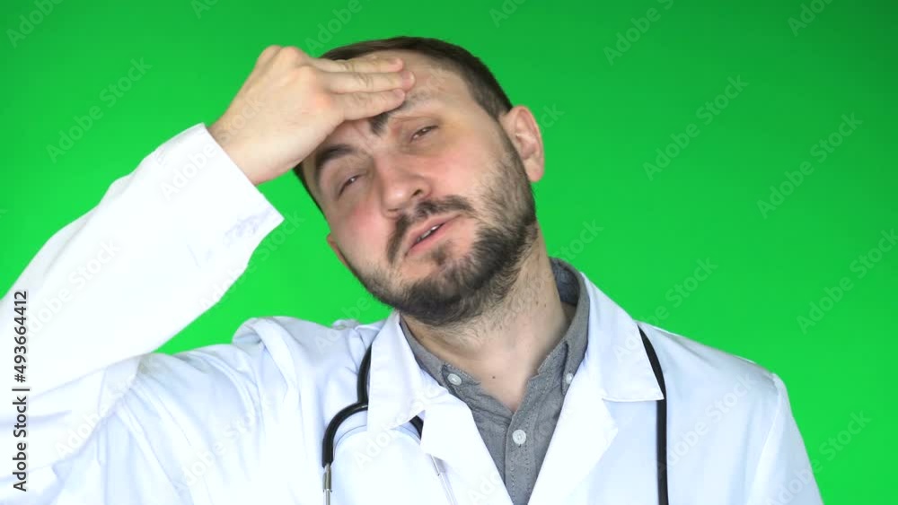 Medical doctor man suffering from headache, migraine attack. Green ...