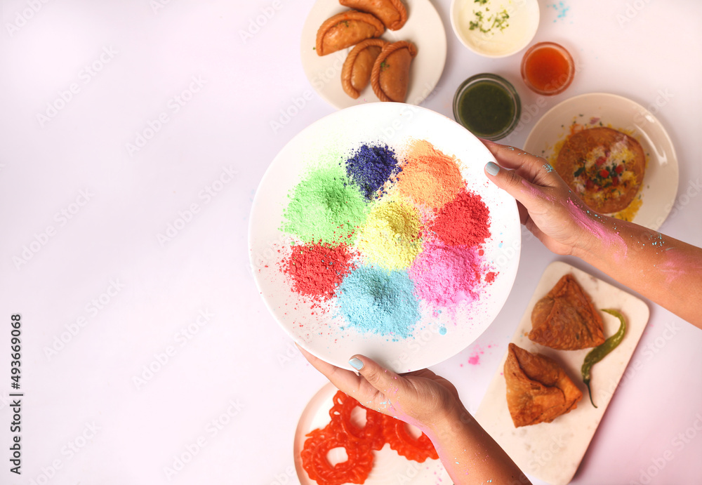 Indian festival colours in plate. Holi festival colours. Girl holding ...