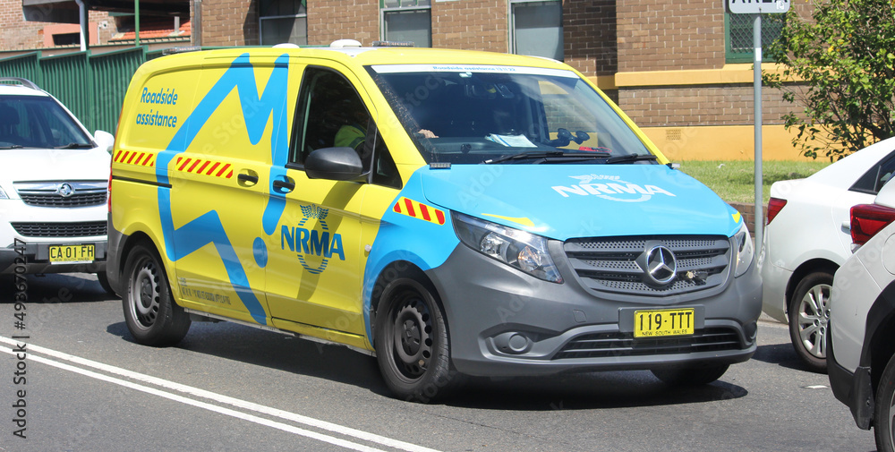 Pictured is a branded NRMA roadside assist van on the street in traffic ...