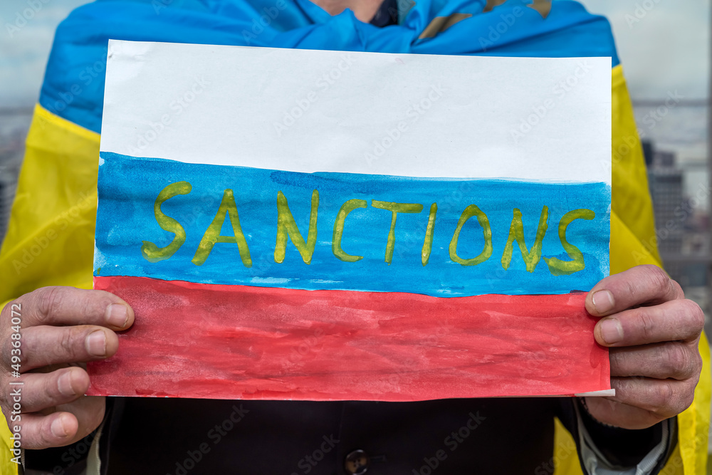 Ukraine man holding poster with message economic sanctions for Russia ...